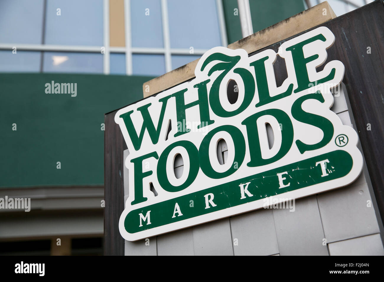 A logo sign outside of the headquarters and a store location of Whole ...