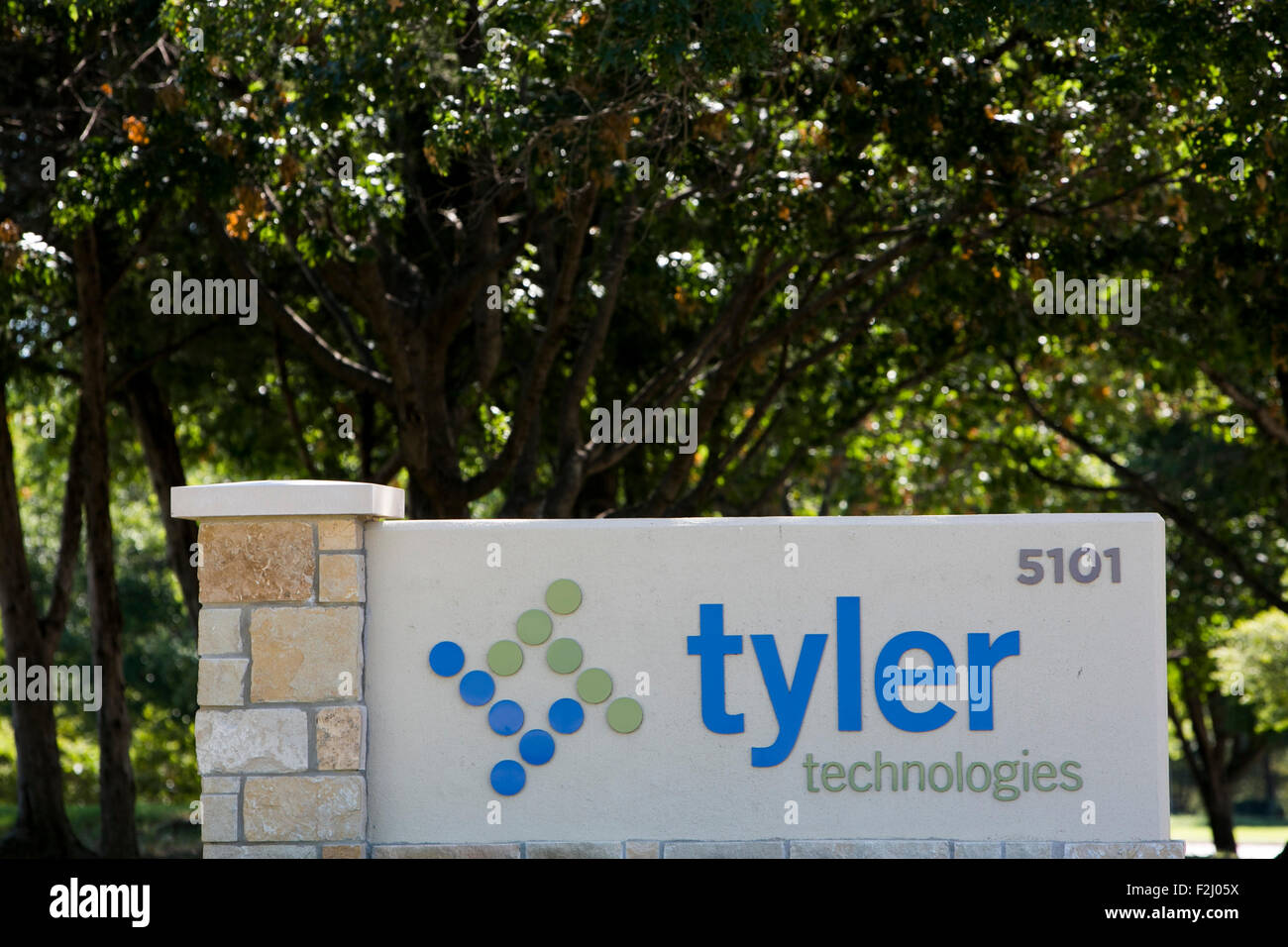 A logo sign outside of the headquarters of Tyler Technologies, Inc., in ...