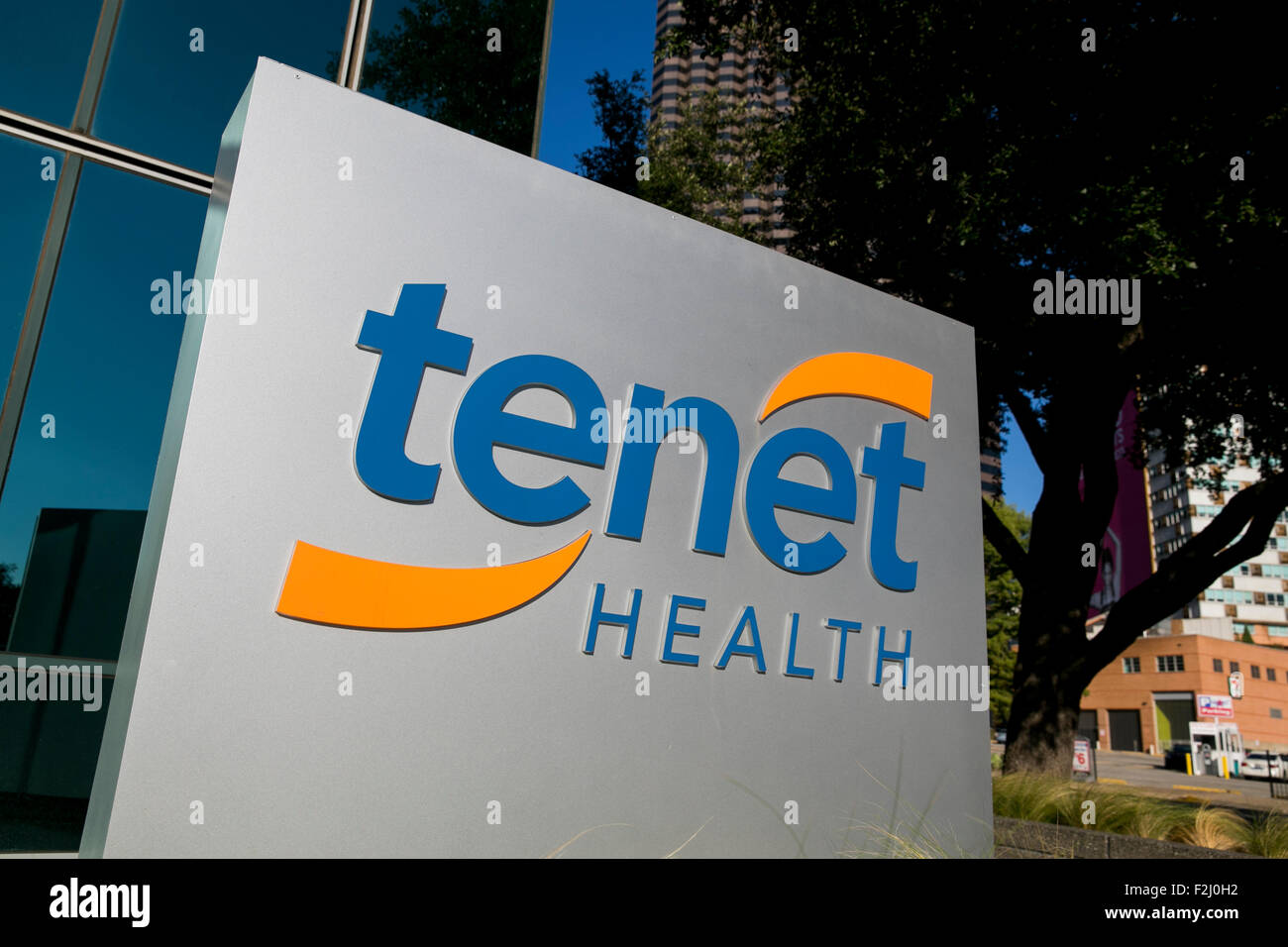 A logo sign outside of the headquarters of the Tenet Healthcare ...