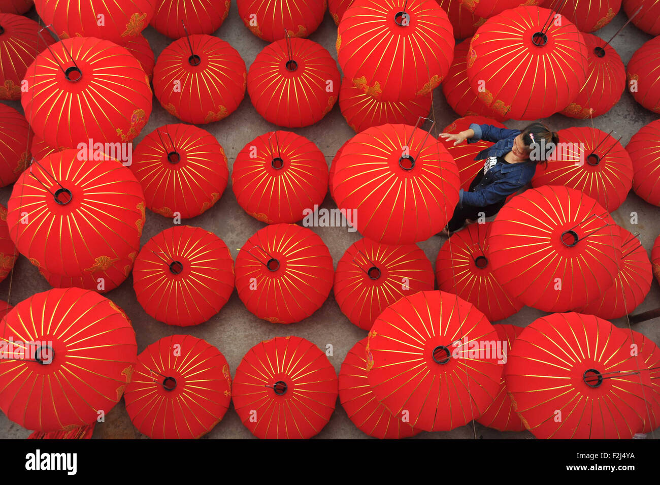 Yuncheng. 19th Sep, 2015. A villager dries newly-made red lanterns at ...