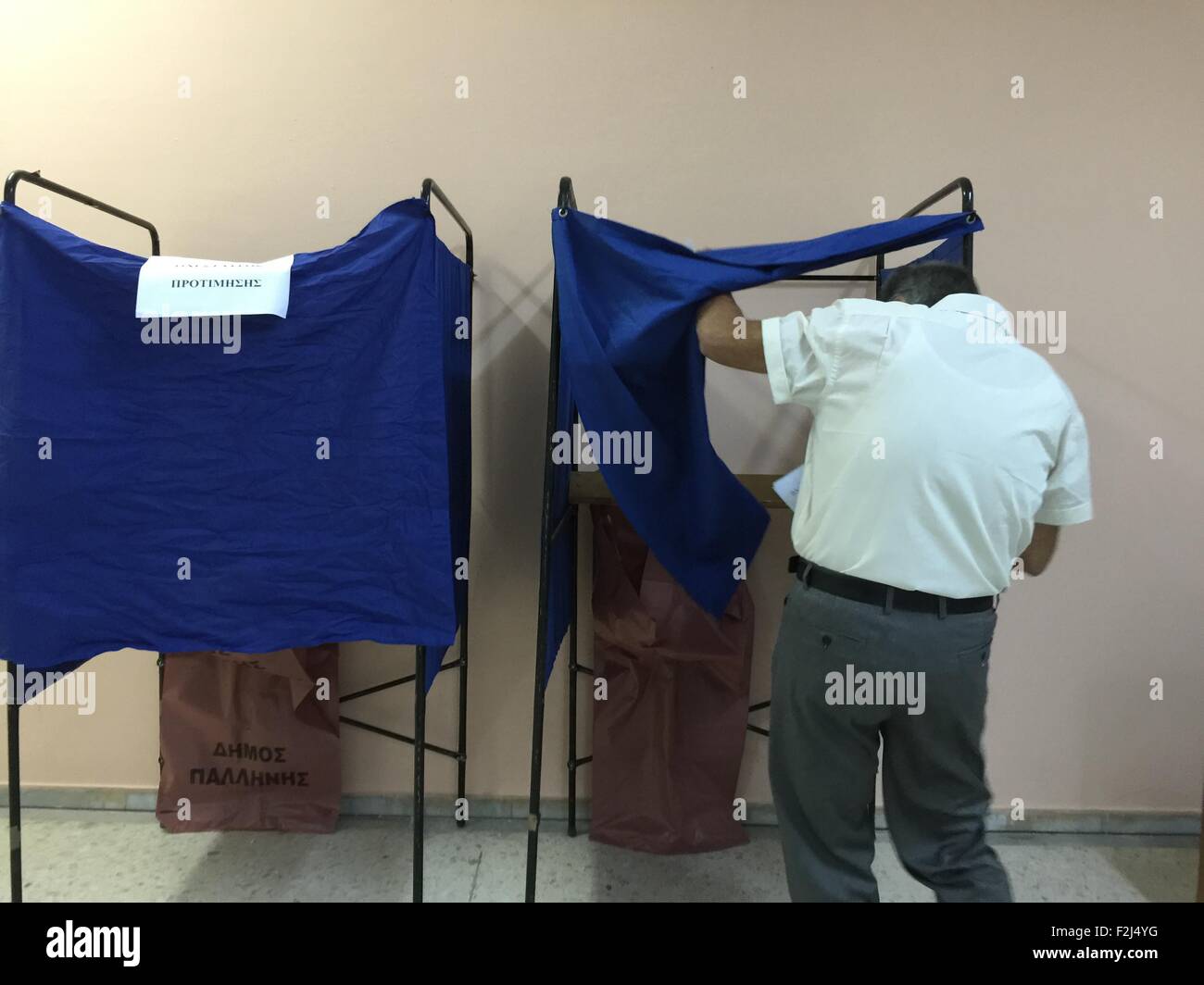 Athens, Sunday. 20th Sep, 2015. A man enters a voting booth before ...