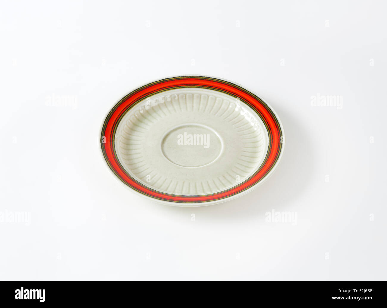 white saucer with red rim on white background Stock Photo - Alamy