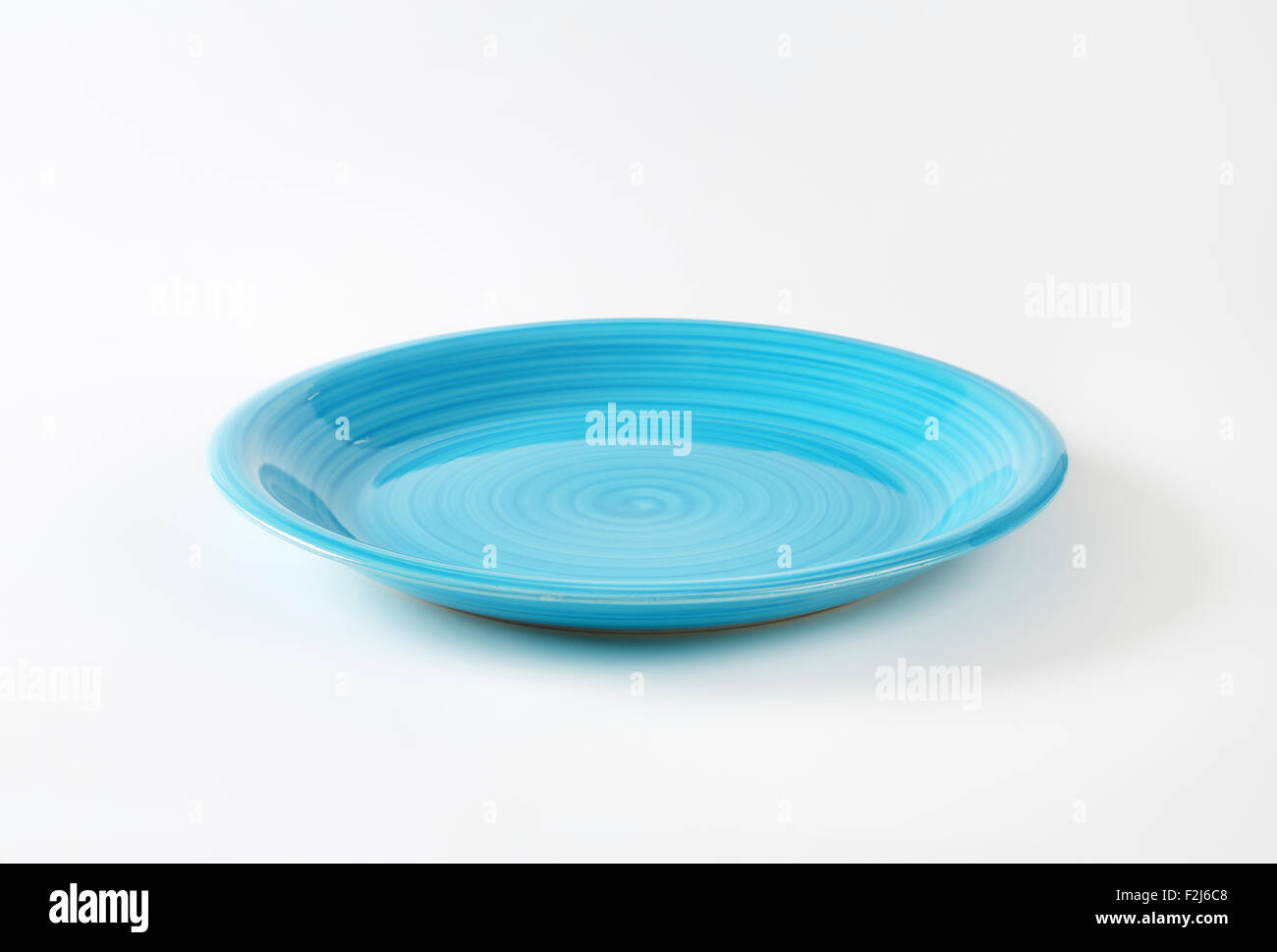 empty blue plate on white background Stock Photo - Alamy