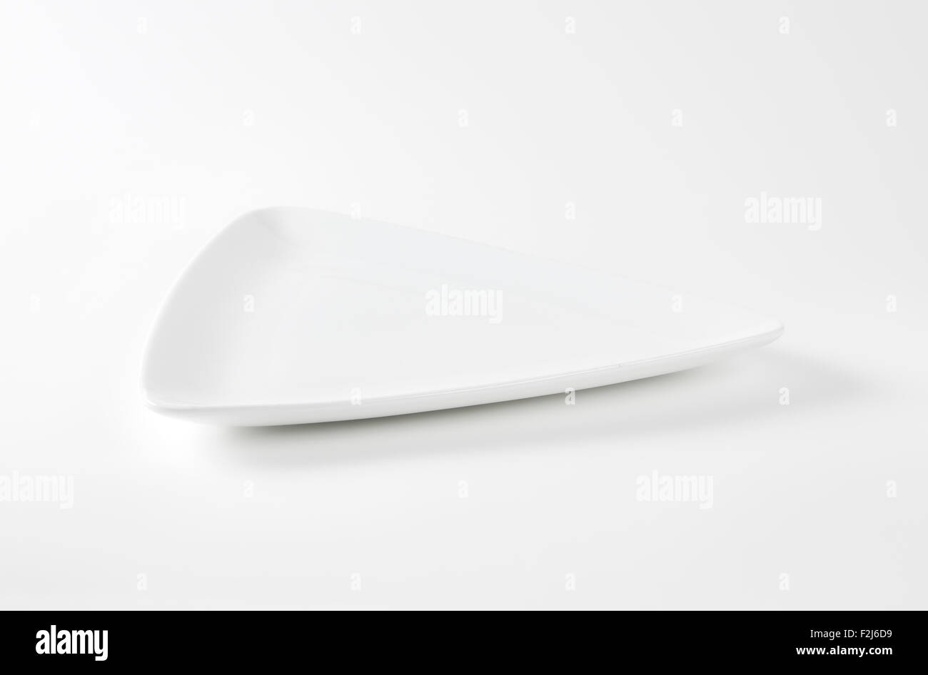 white triangular plate on white background Stock Photo - Alamy