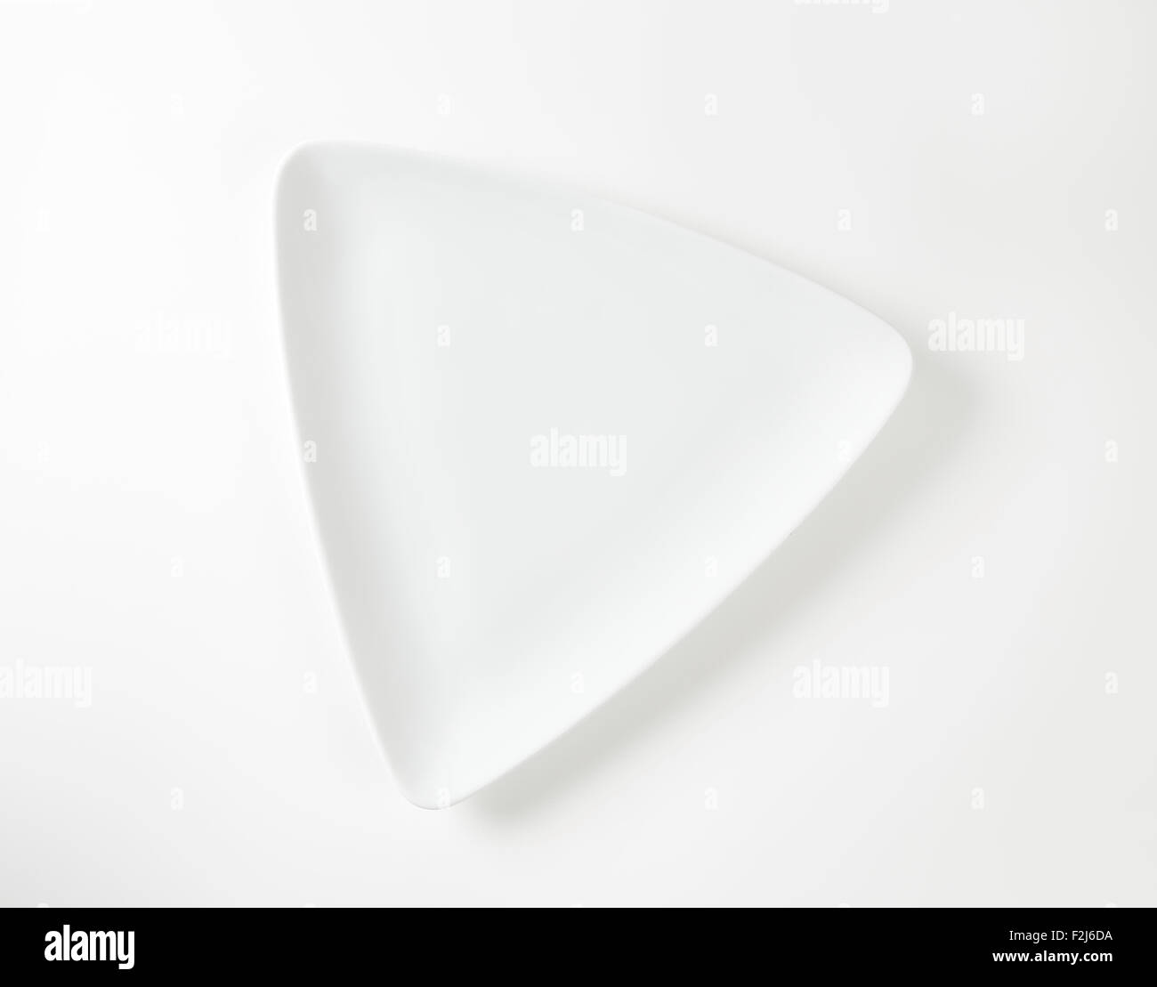 white triangular plate on white background Stock Photo - Alamy