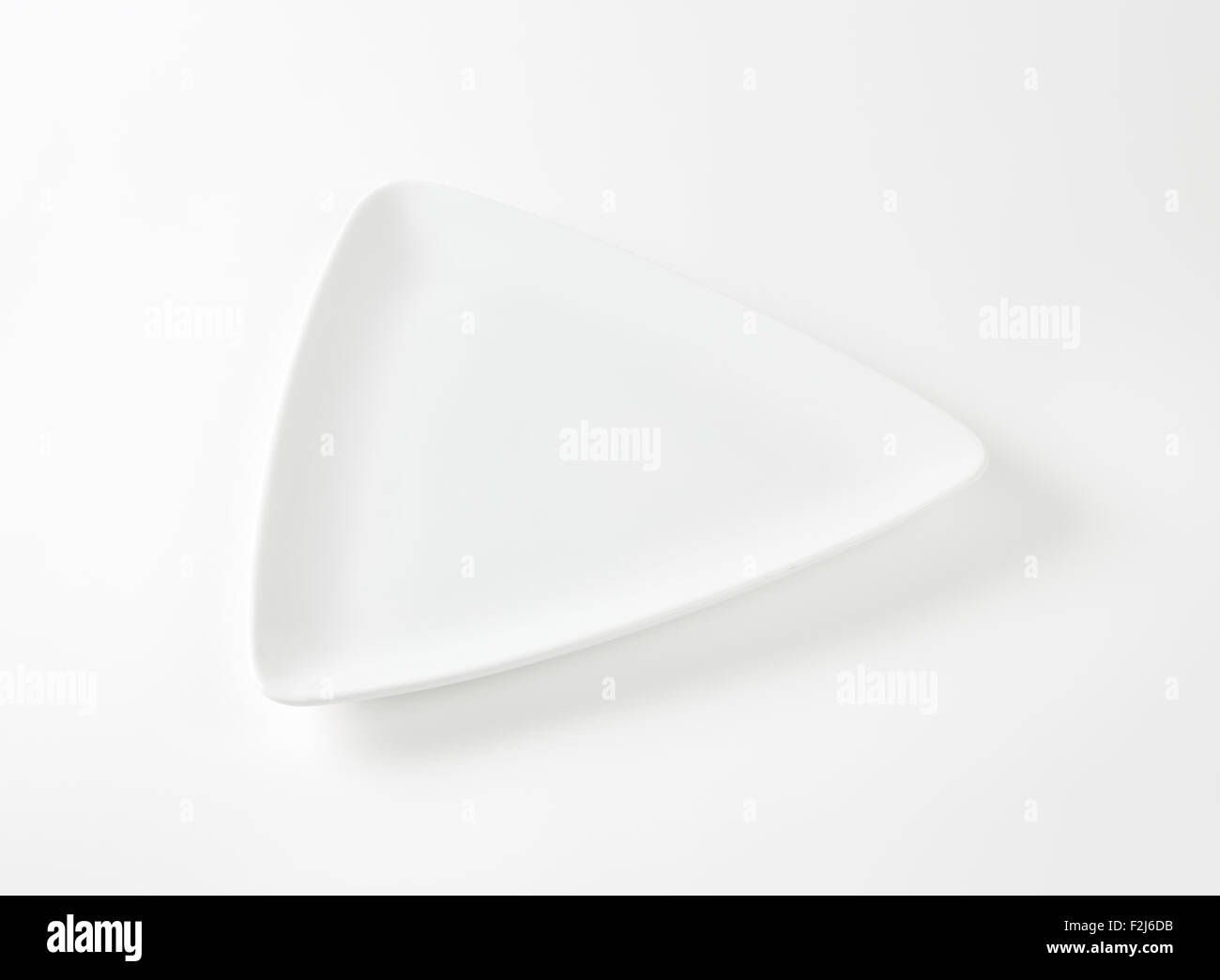white triangular plate on white background Stock Photo - Alamy