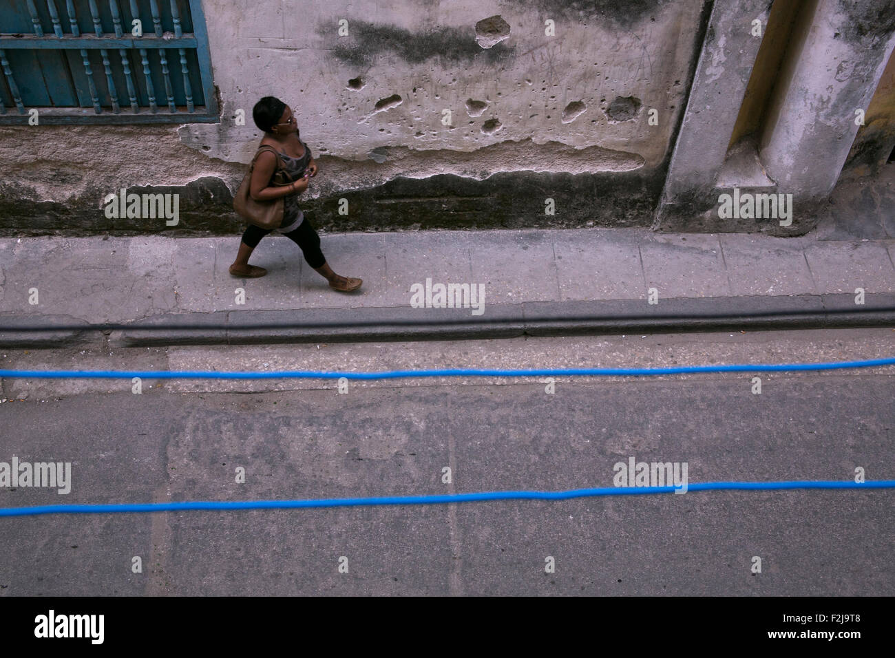 A woman walking in front of the St. Clare convent in Old Havana, Cuba ...