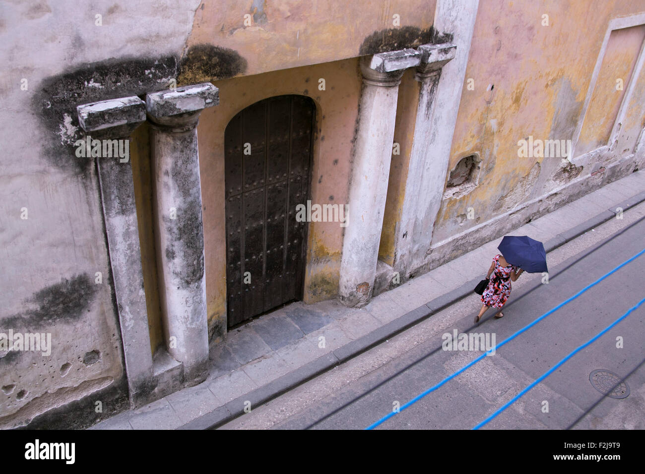 A woman walking in front of the St. Clare convent in Old Havana, Cuba ...