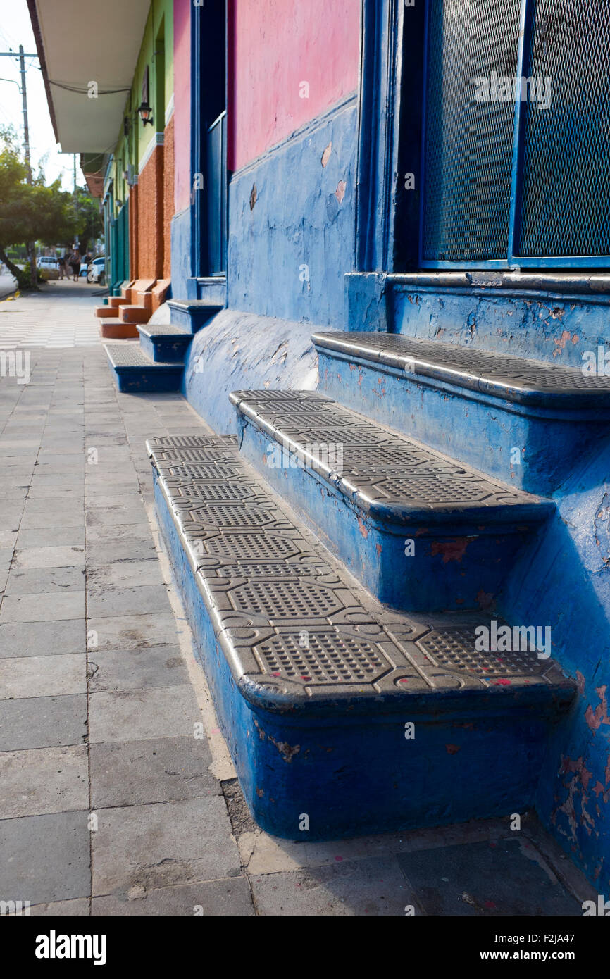 A row of brightly painted coloured steps infront of houses, in the ...