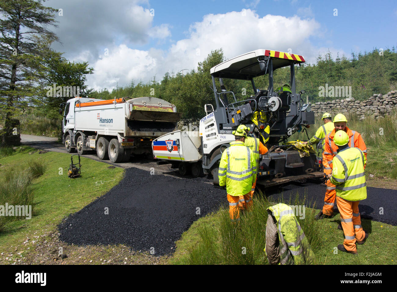 County Council workers laying tarmac on rural road in Cumbria, UK Stock ...