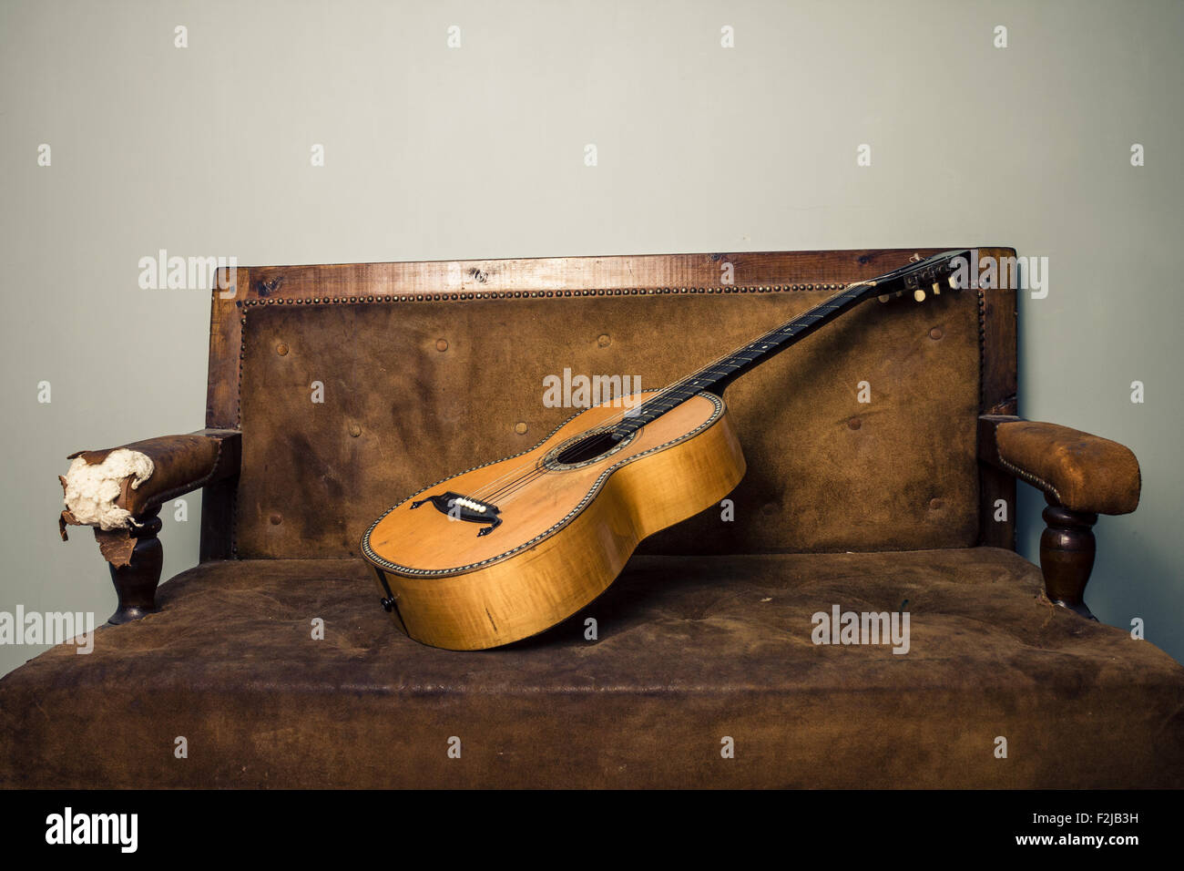 Guitar on sofa Stock Photo - Alamy