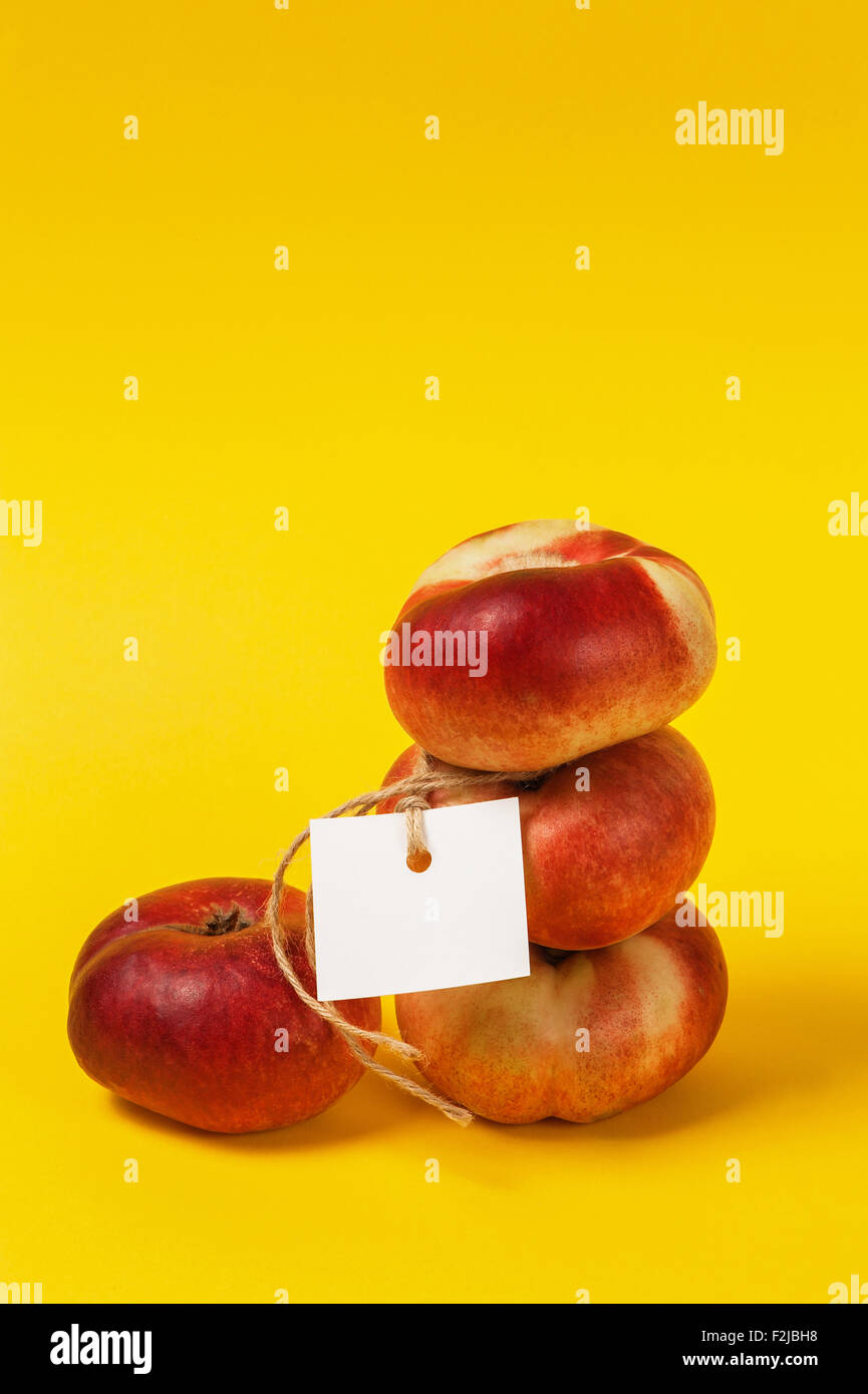 Ripe nectarine with label on the yellow background Stock Photo - Alamy