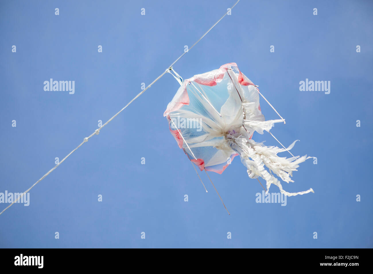Hanging jellyfish made of recycled plastic over blue sky Stock Photo ...