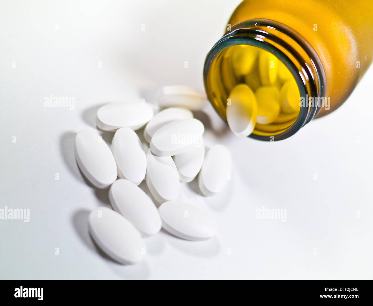 pills an pill bottle on white background Stock Photo - Alamy