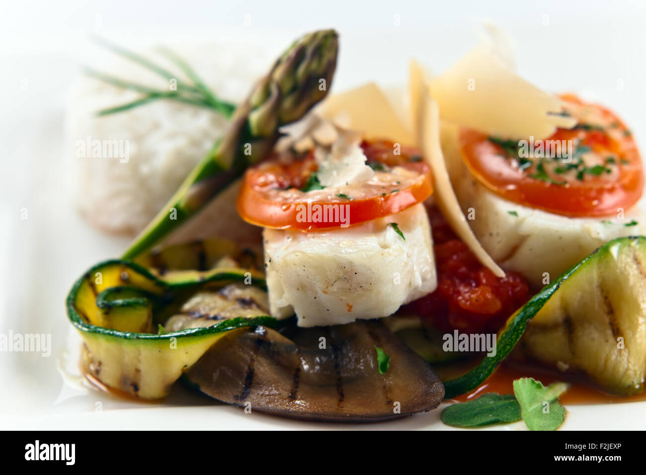 fresh baked halibut with vegetables and spices Stock Photo - Alamy