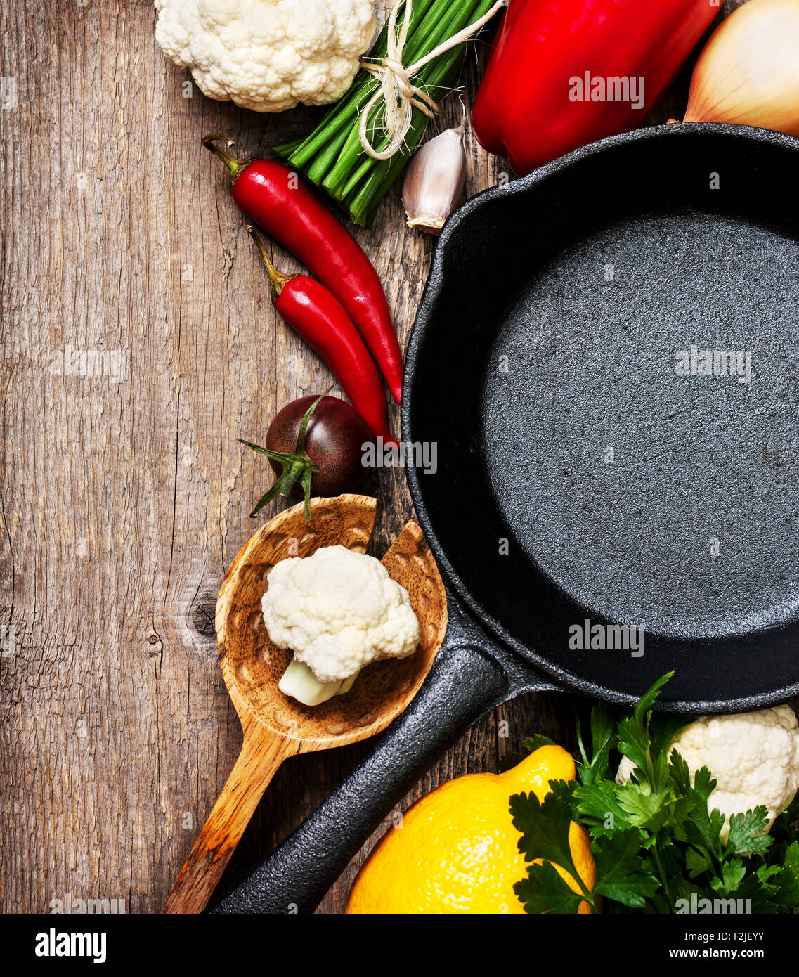 cast iron pan and fresh vegetables for the preparation of healthy ...