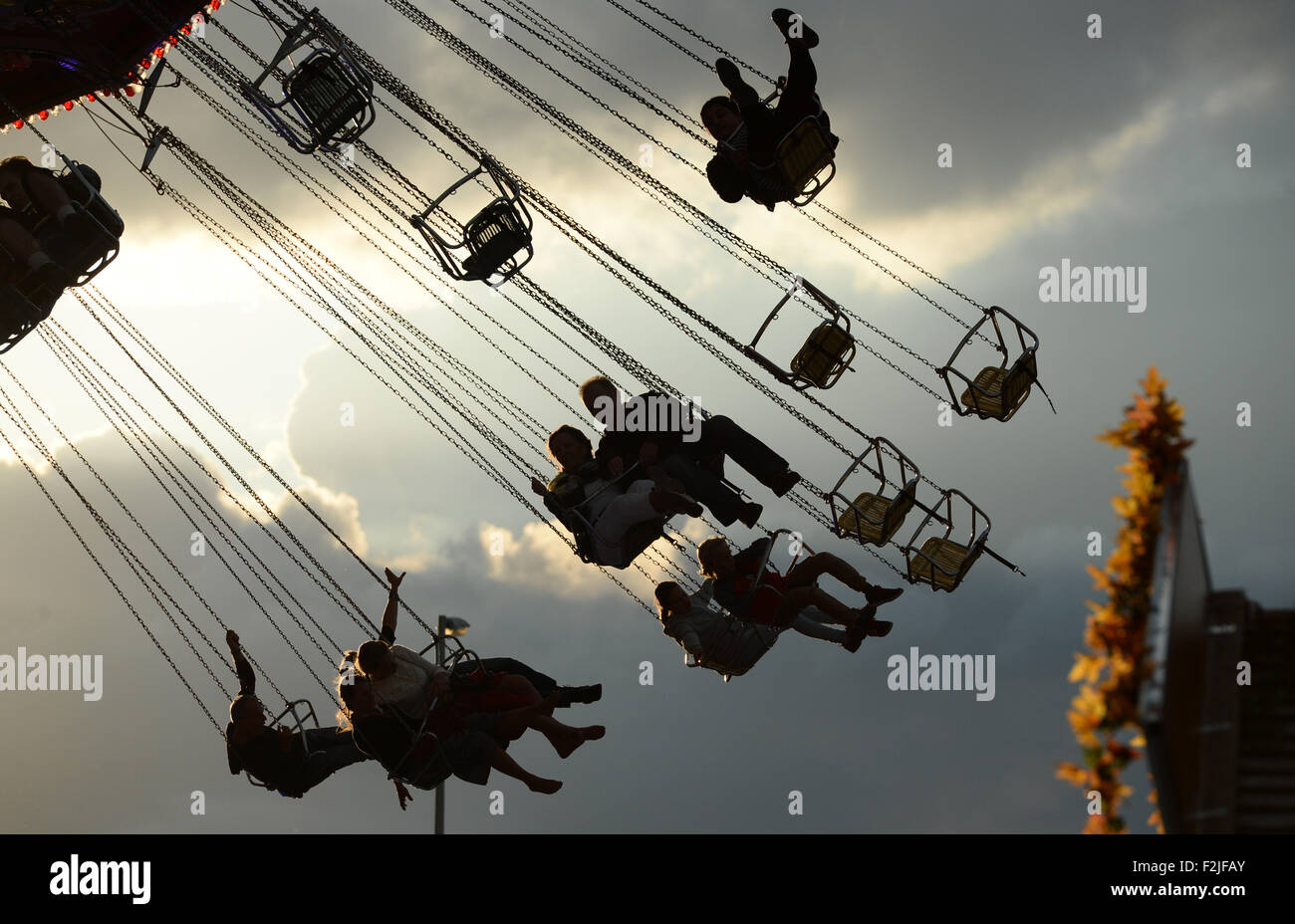 Munich, Germany. 19th Sep, 2015. Visitor take a ride on a swing ...