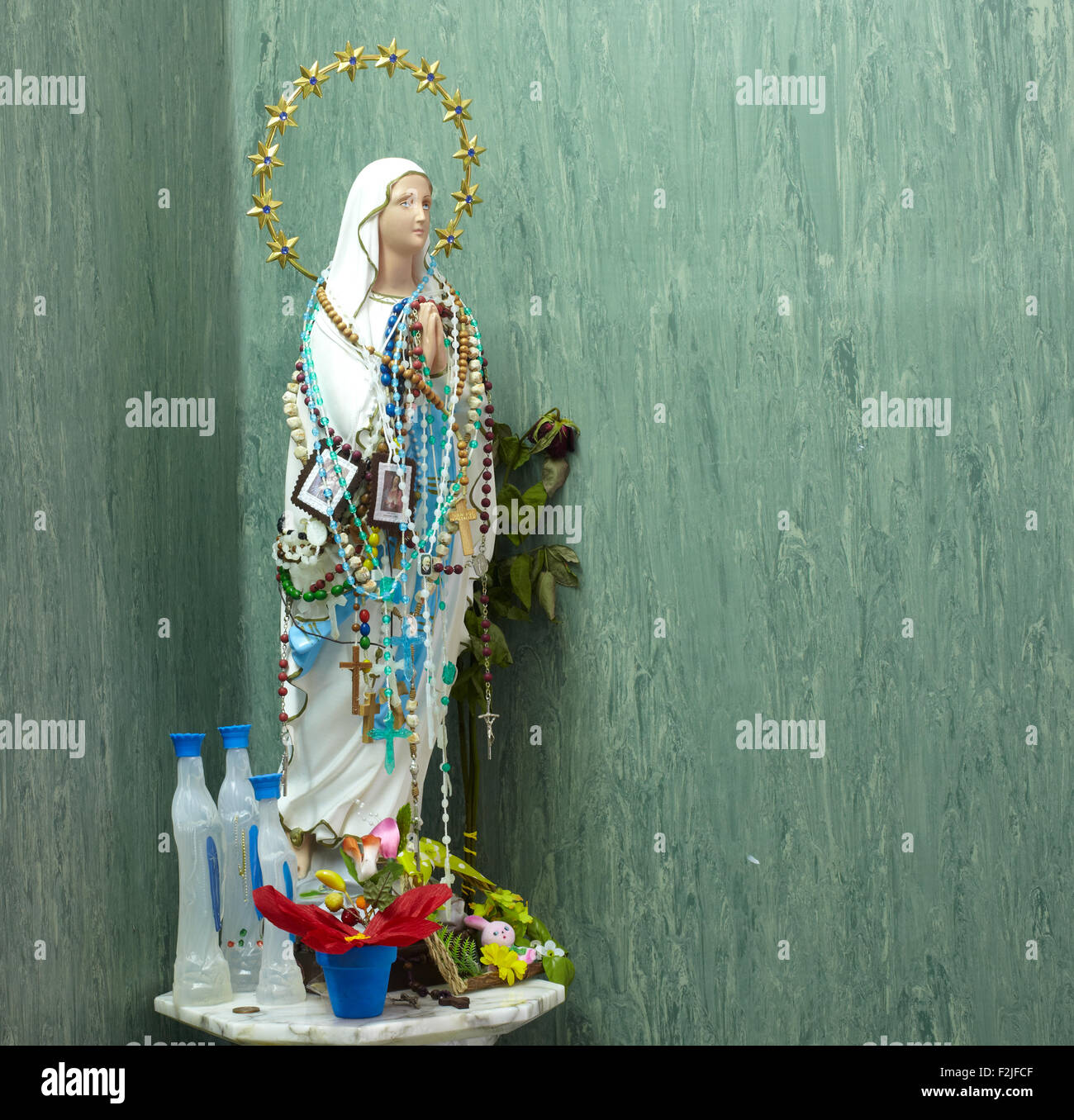 Statue of Virgin Mary covered with rosaries Stock Photo - Alamy