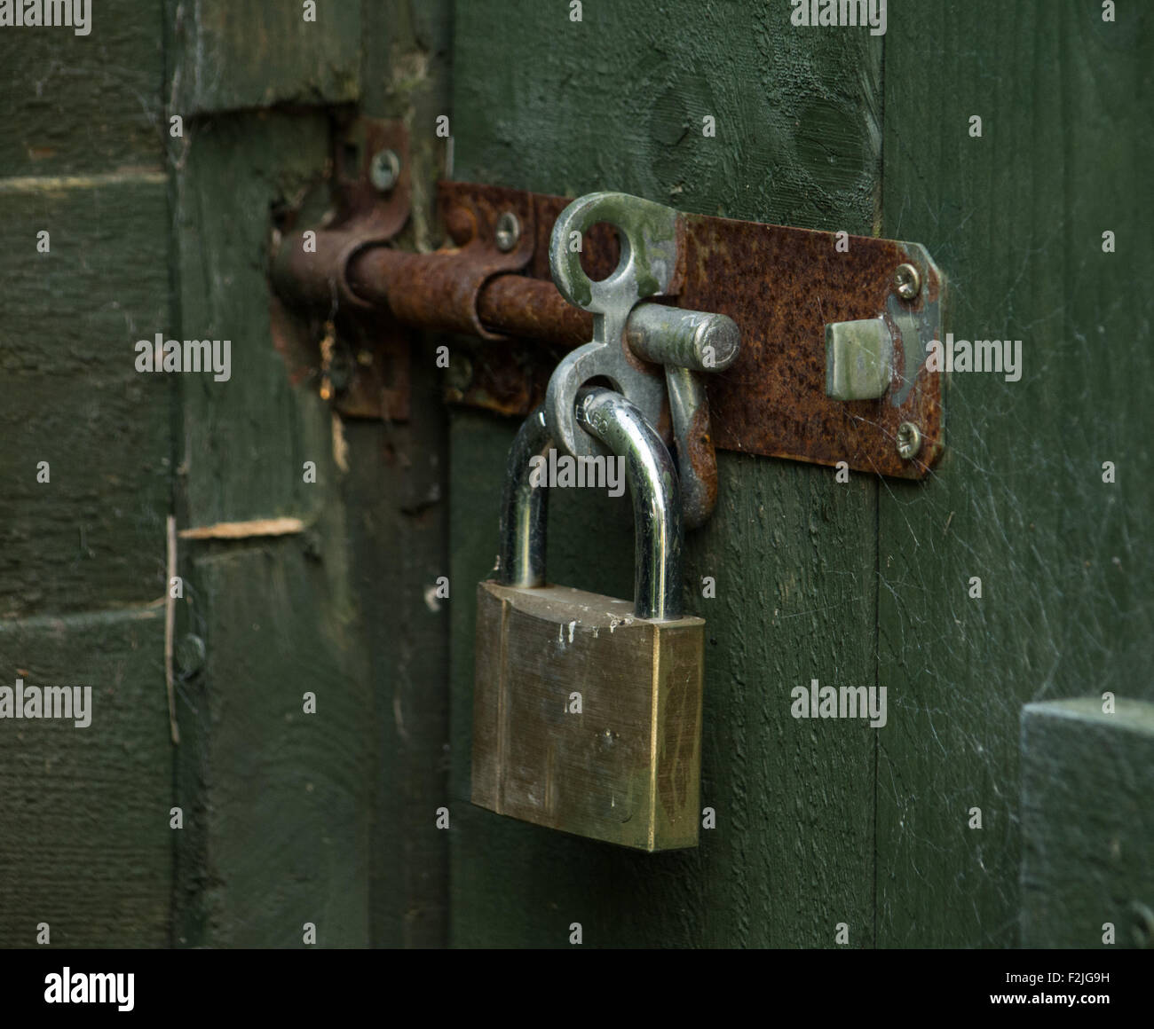 Padlock on rusty bolt Stock Photo - Alamy