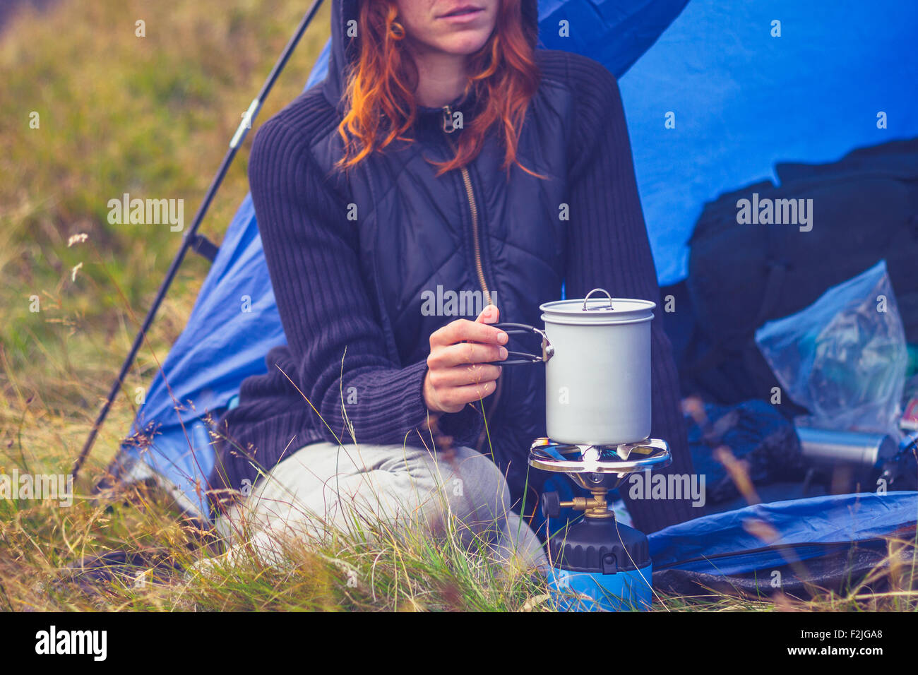Woman cooking in shelter hi-res stock photography and images - Alamy