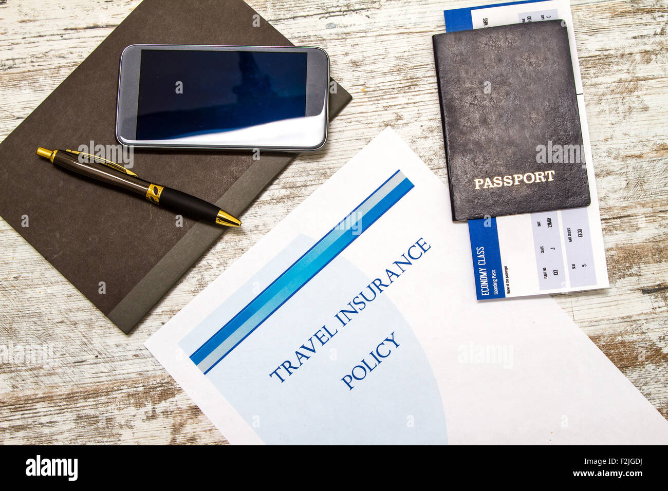 Travel insurance policy booklet with a boarding pass and a passport ...