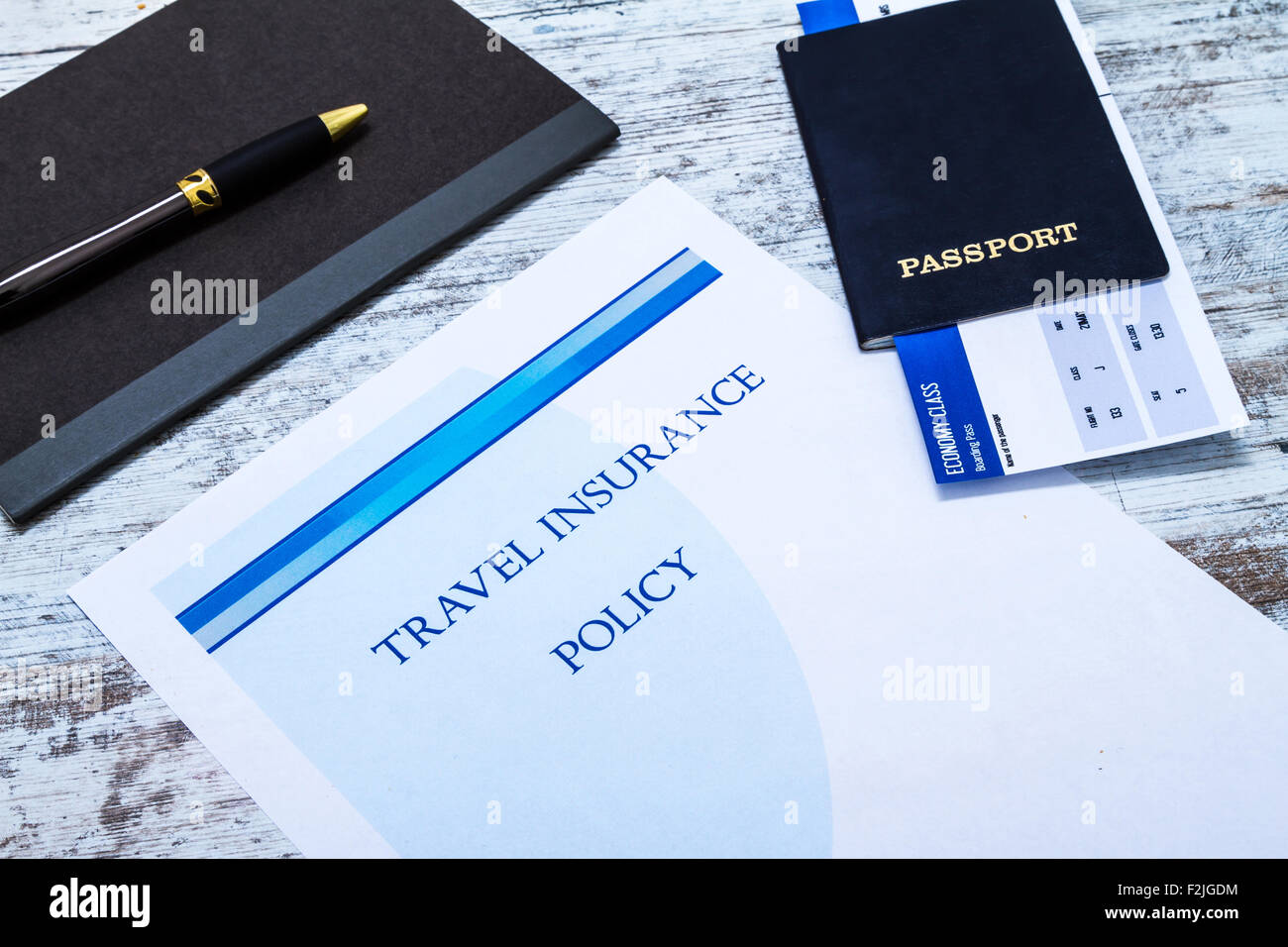 Travel insurance policy booklet with a boarding pass and a passport ...