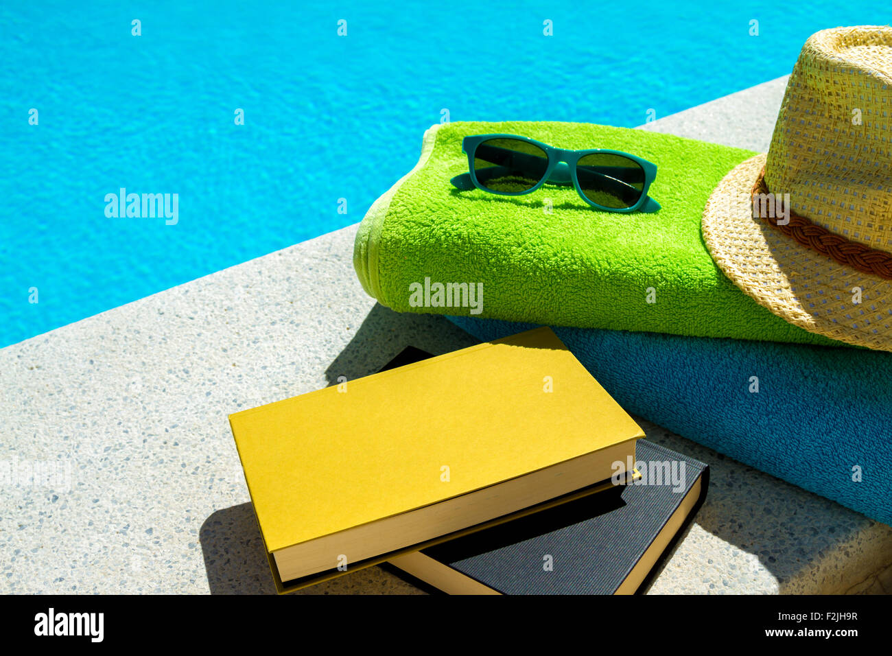 Reading near the swimming pool Stock Photo - Alamy