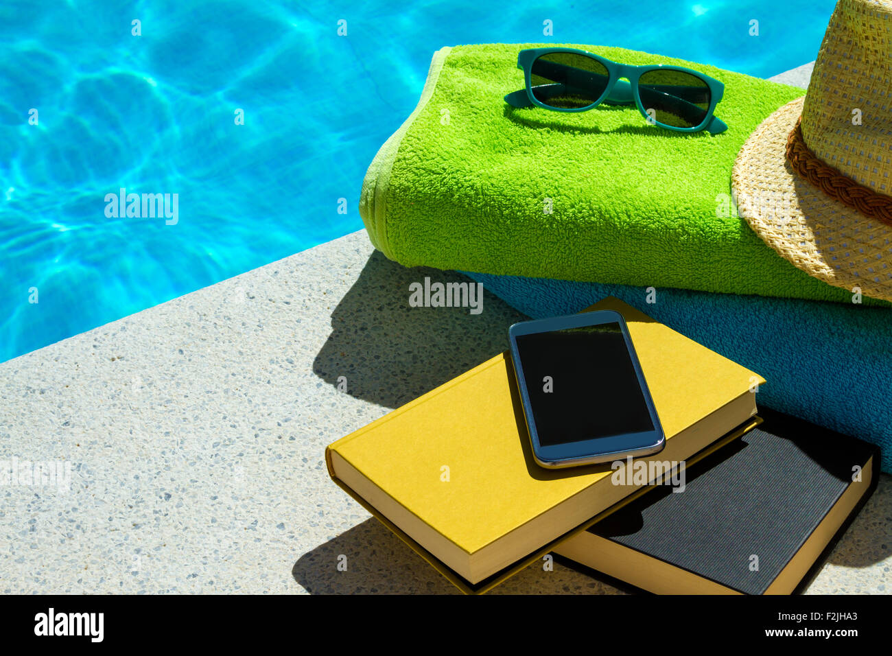 Reading near the swimming pool Stock Photo - Alamy
