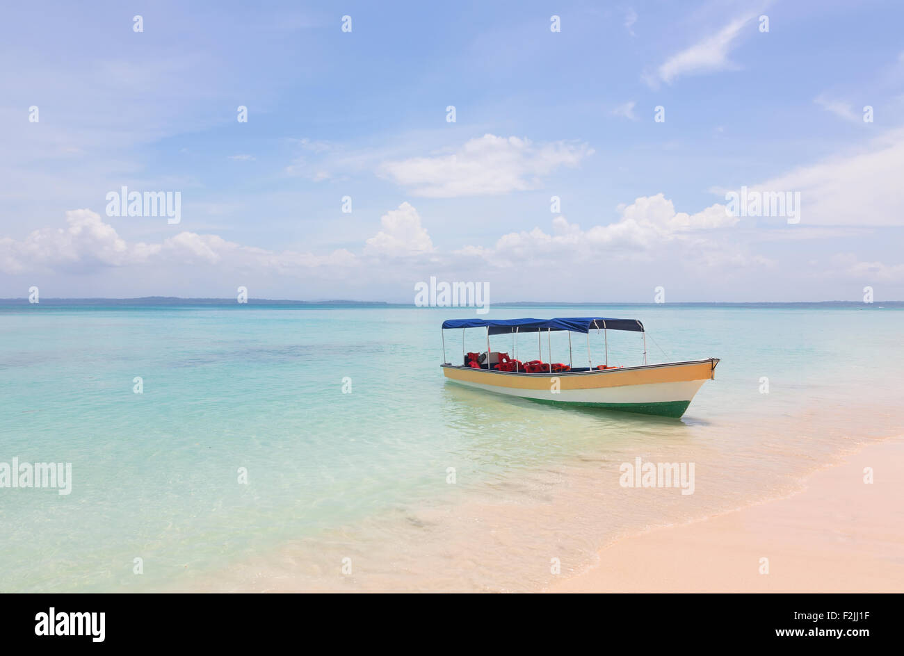 Boat on the beautiful tropical beach Stock Photo - Alamy