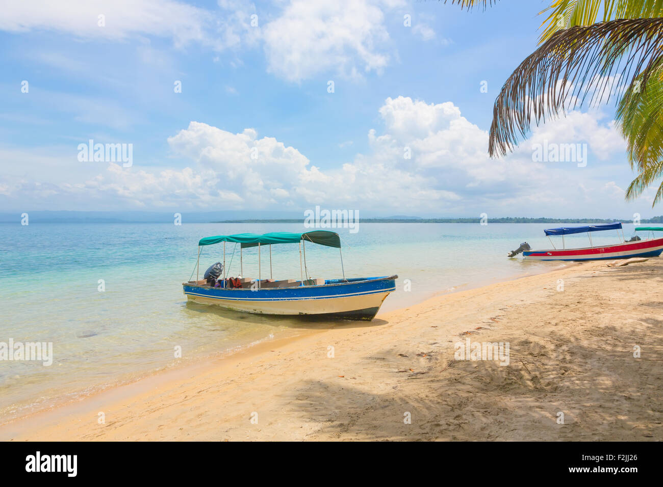 Boat on the beautiful tropical beach Stock Photo - Alamy