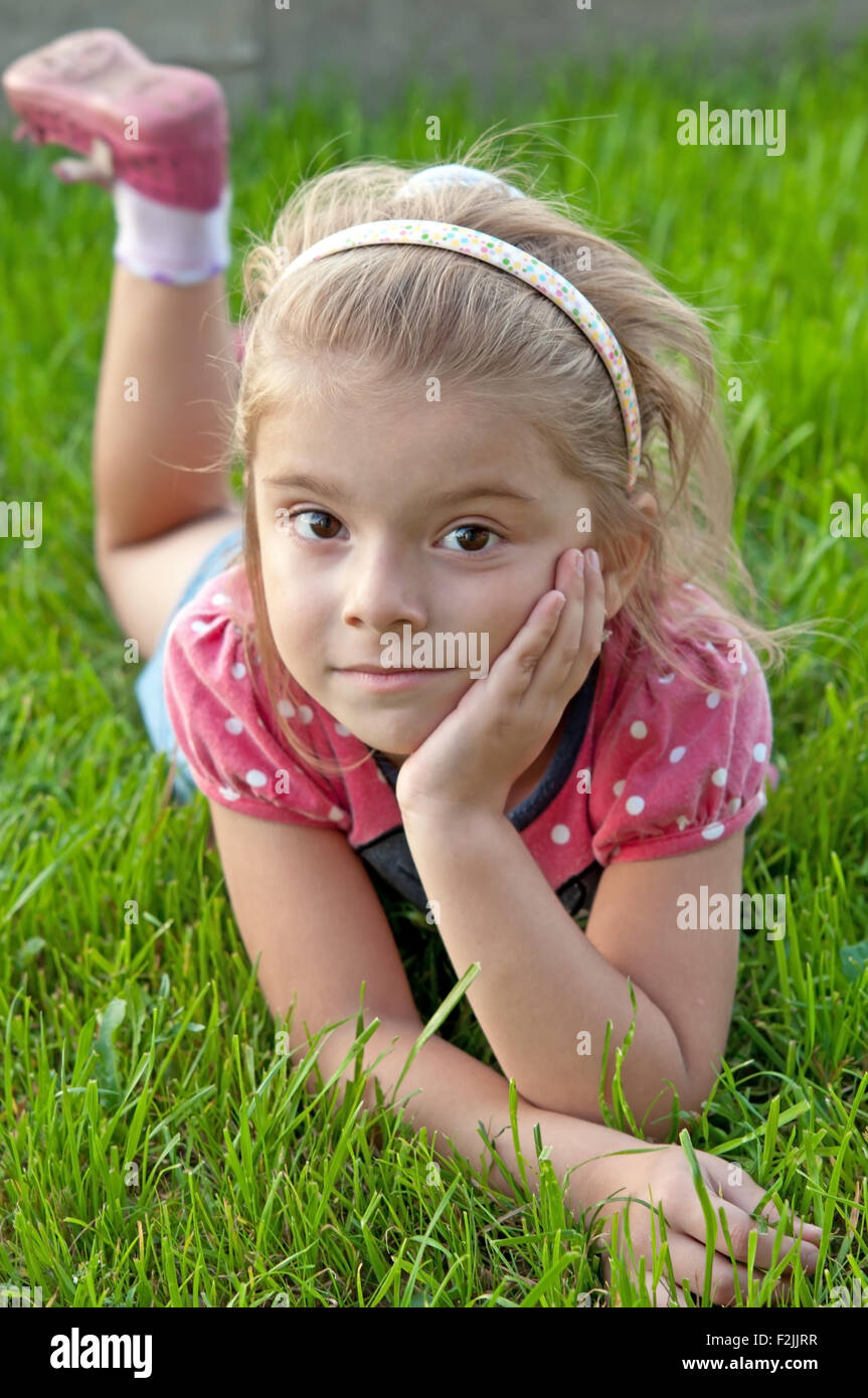 girl lying on green grass Stock Photo - Alamy