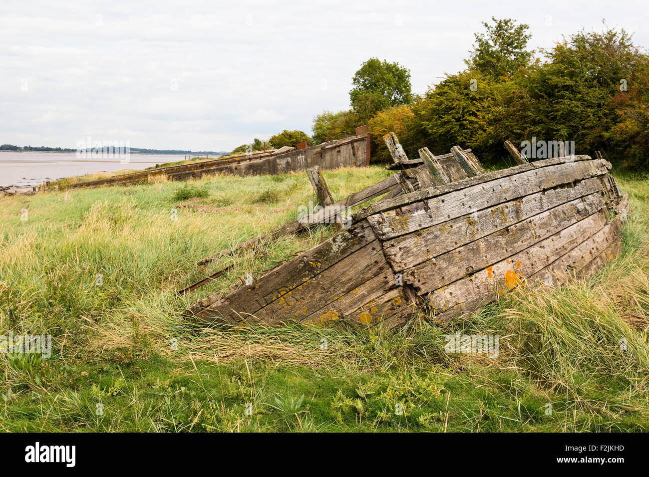 Abandoned boats at Purton ship graveyard on the bank of the river ...