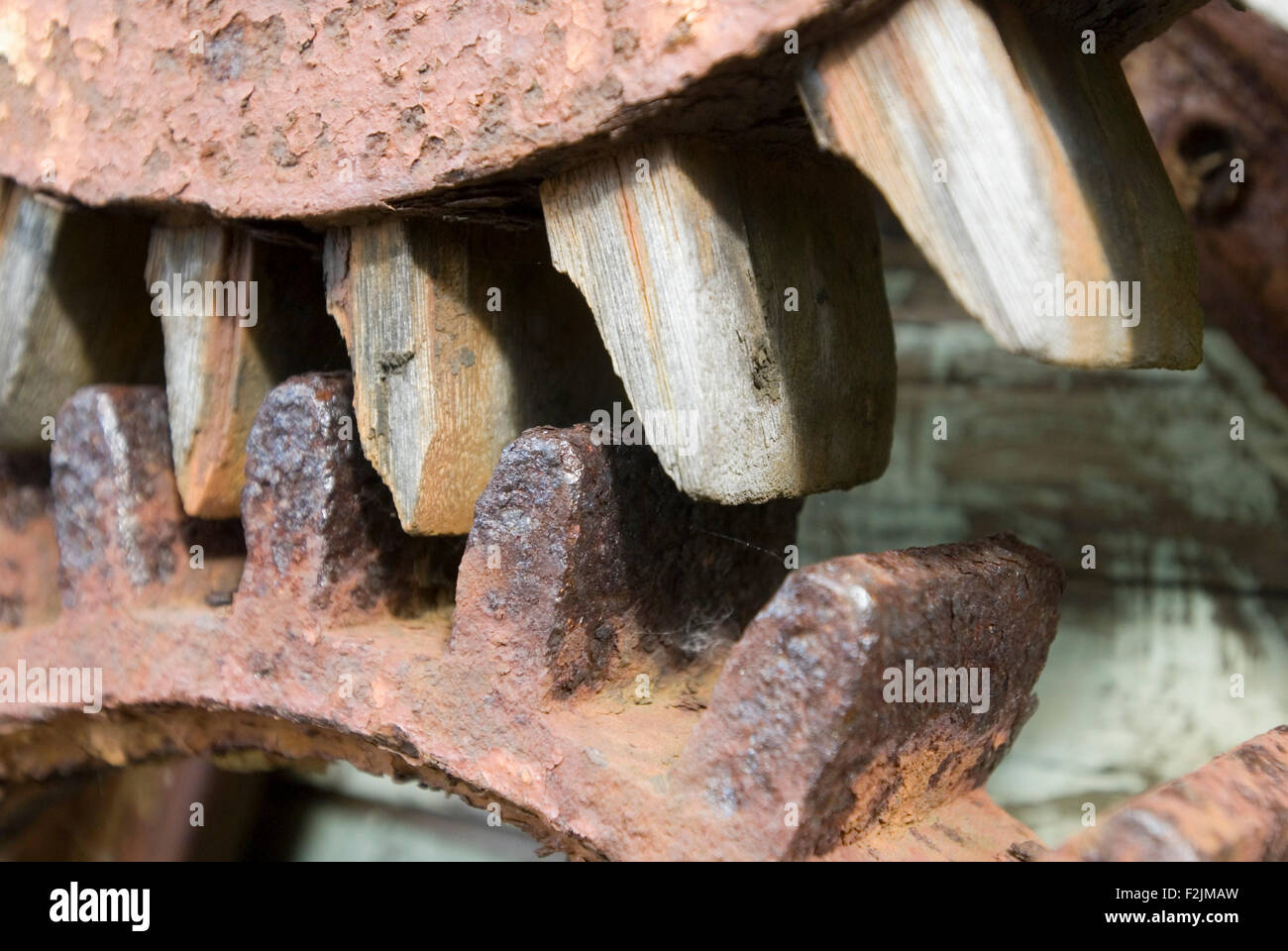 Cogwhell metal and wooden teeth rustily Stock Photo - Alamy
