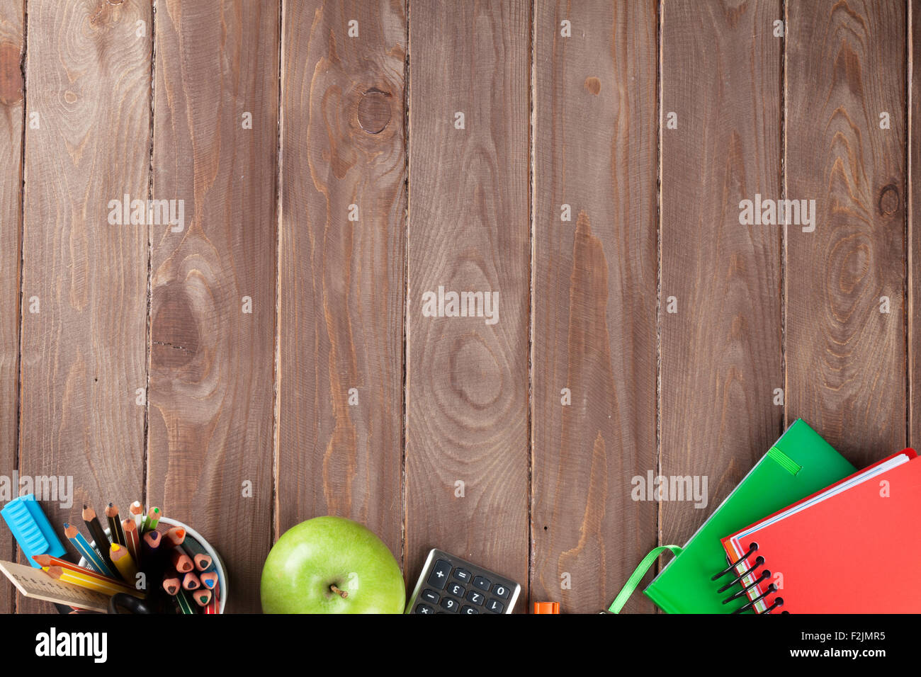 School and office supplies on classroom table. Top view with copy space ...