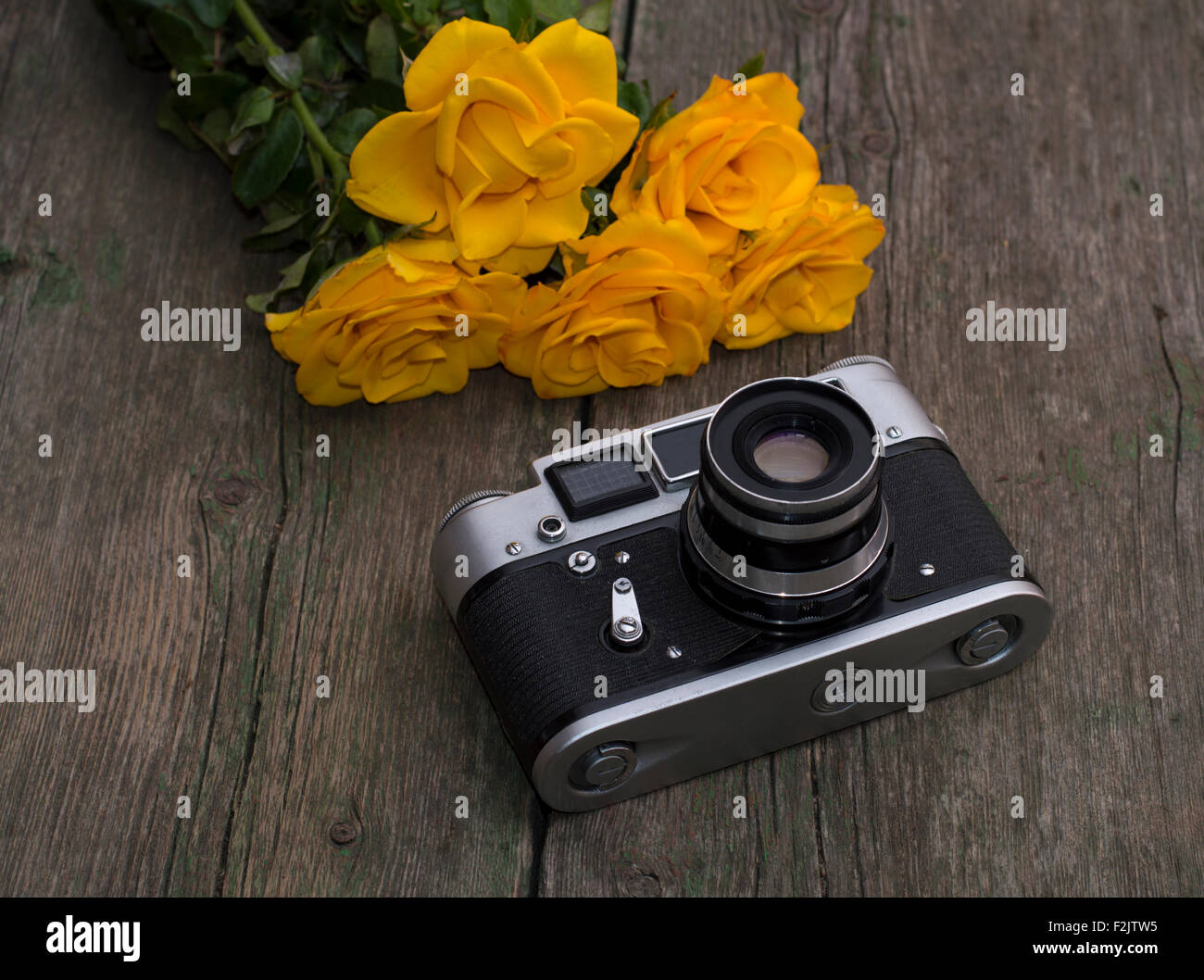 film retro camera and bouquet of yellow roses Stock Photo - Alamy