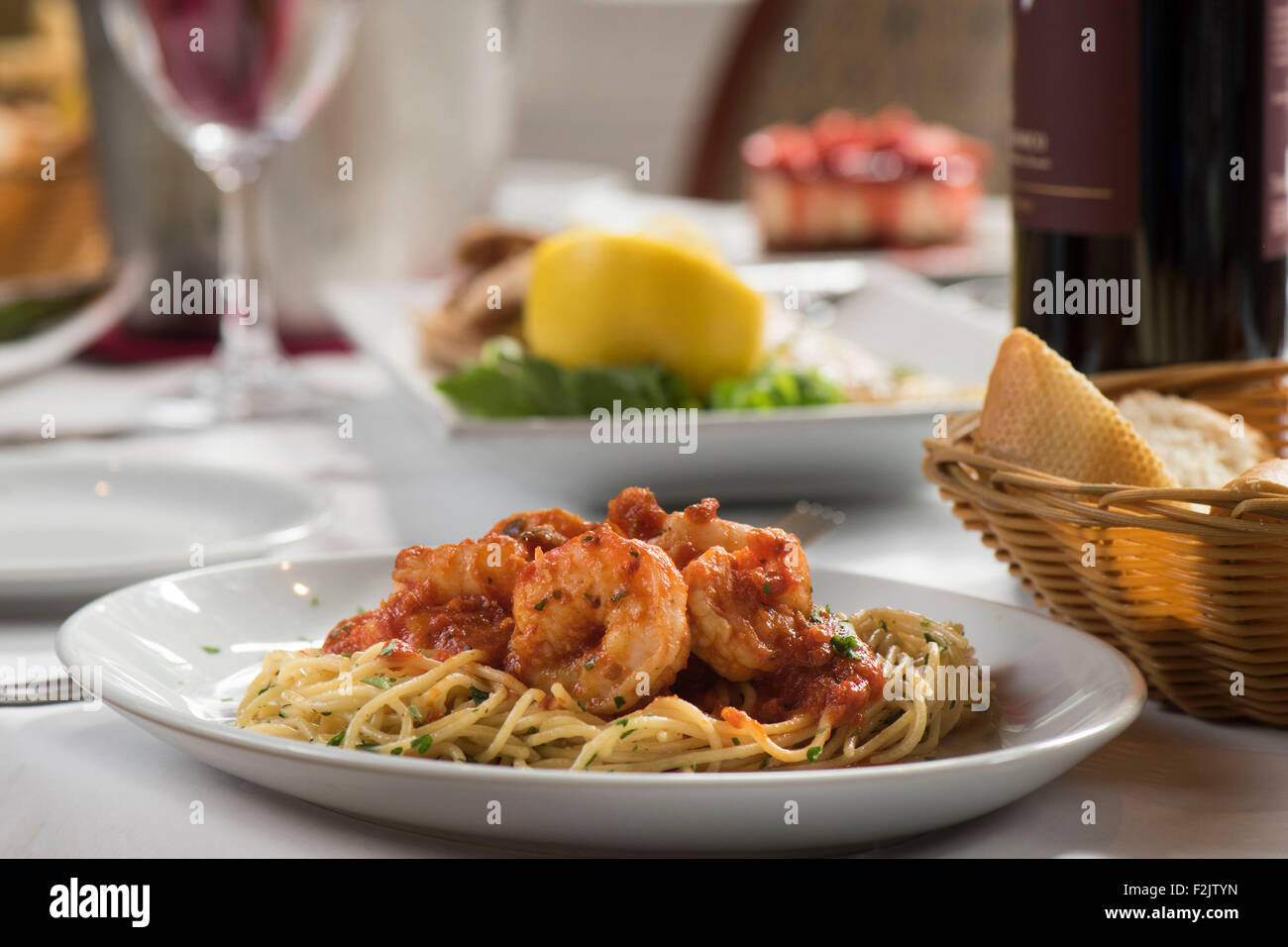 Meal of Italian king prawns in tomato sauce on spaghetti served on ...