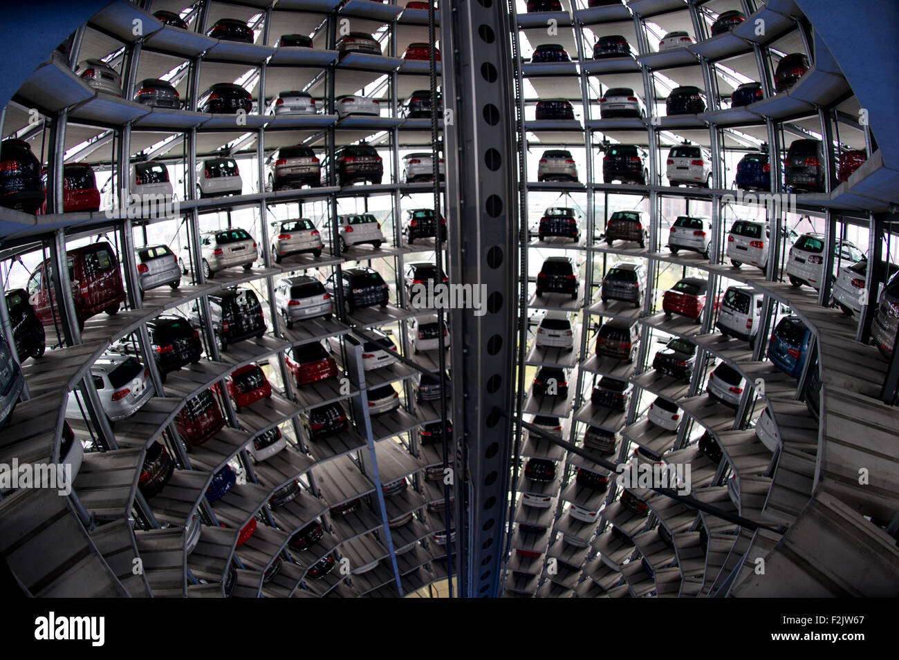 Volkswagen cars are parked inside the sales tower of the VW Autostadt ...