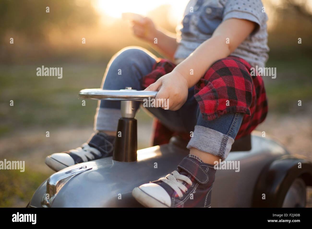 Little racer and tiny race car Stock Photo - Alamy