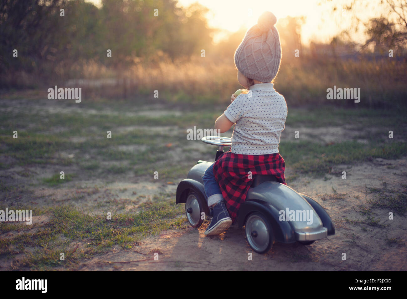 Little driver and tiny race car Stock Photo - Alamy