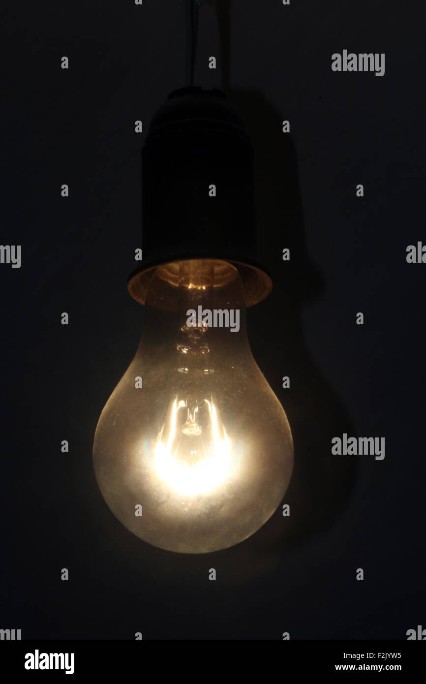 old electric light hanging in the darkness Stock Photo - Alamy