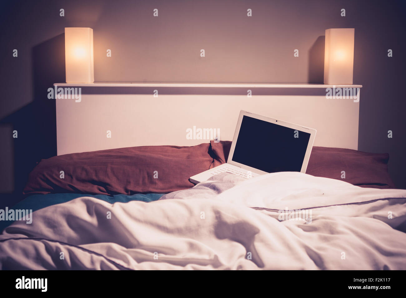 Laptop in bed at night Stock Photo - Alamy