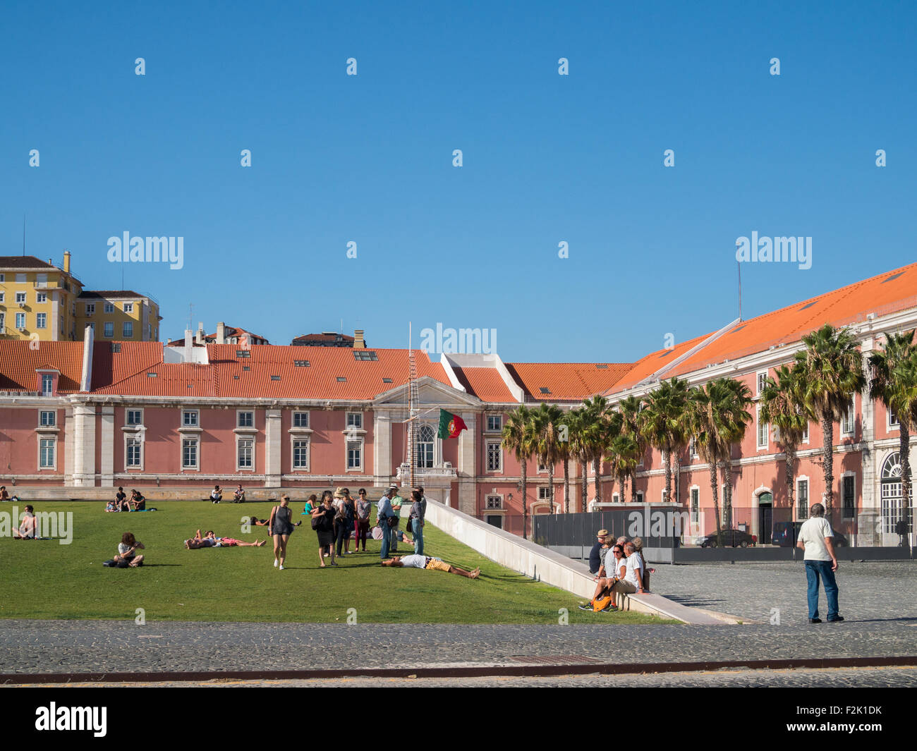 People sunbathing i the riverside park at Ribeira das Naus downtown ...