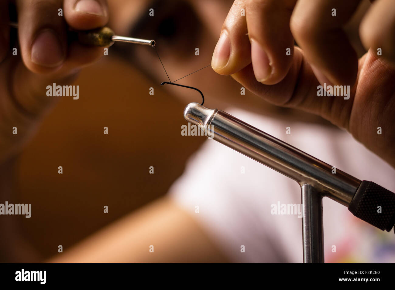 Hands tying hook hi-res stock photography and images - Alamy