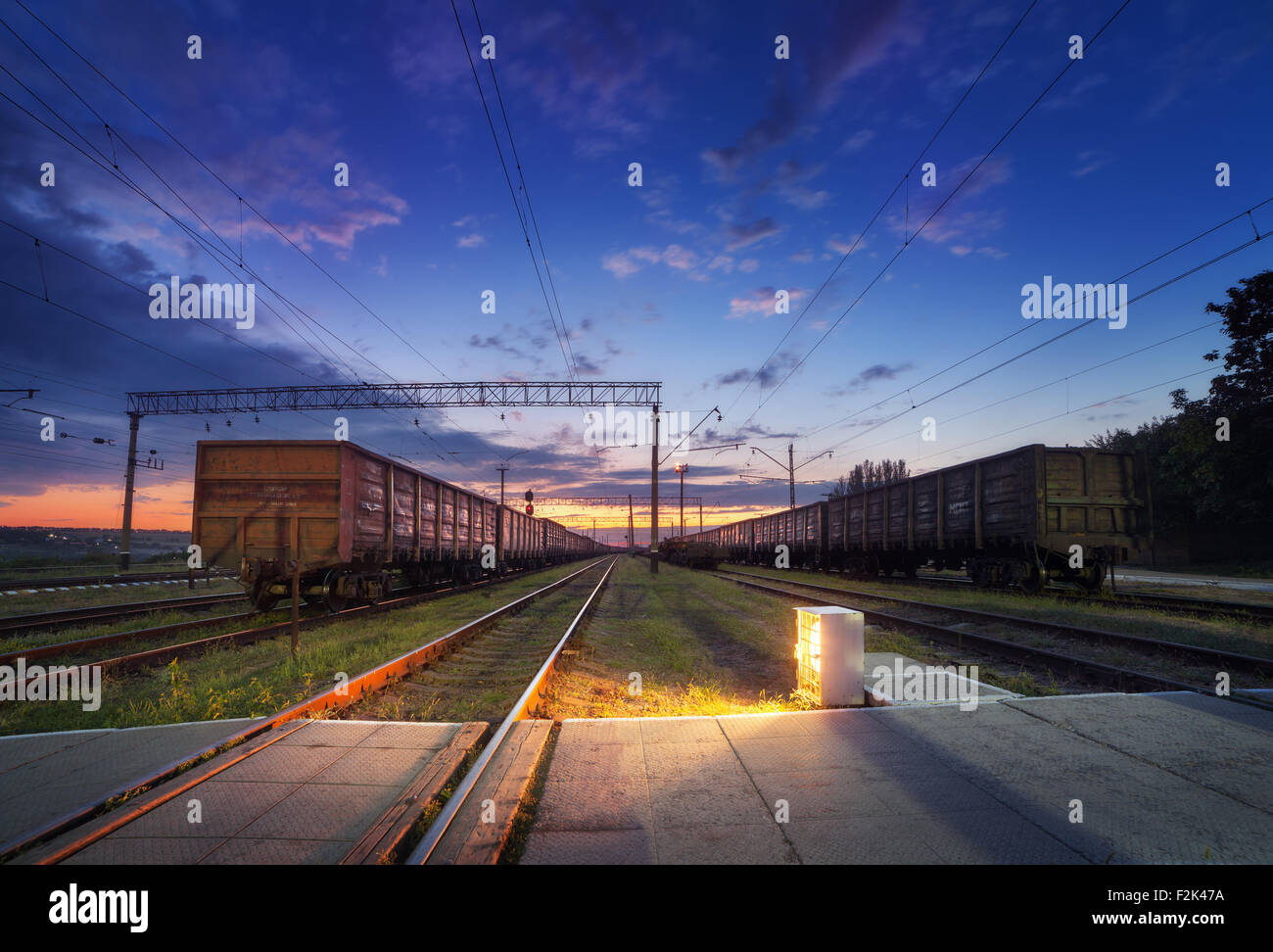 Cargo train platform at sunset. Railroad in Ukraine. Railway station ...