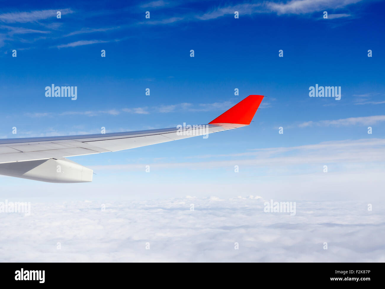 Plane wing, white clouds and blue sky Stock Photo - Alamy
