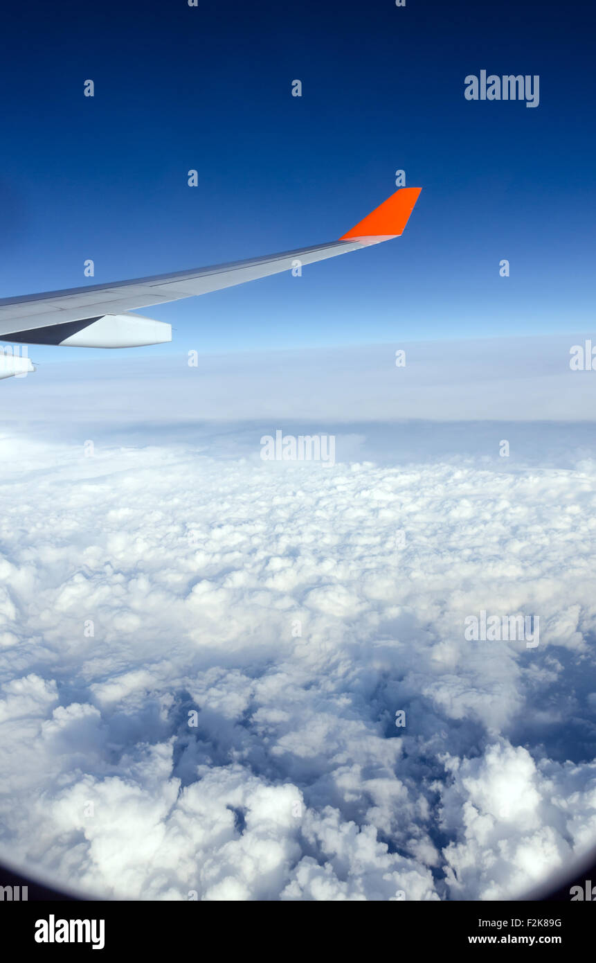 Plane wing, white clouds and blue sky Stock Photo - Alamy