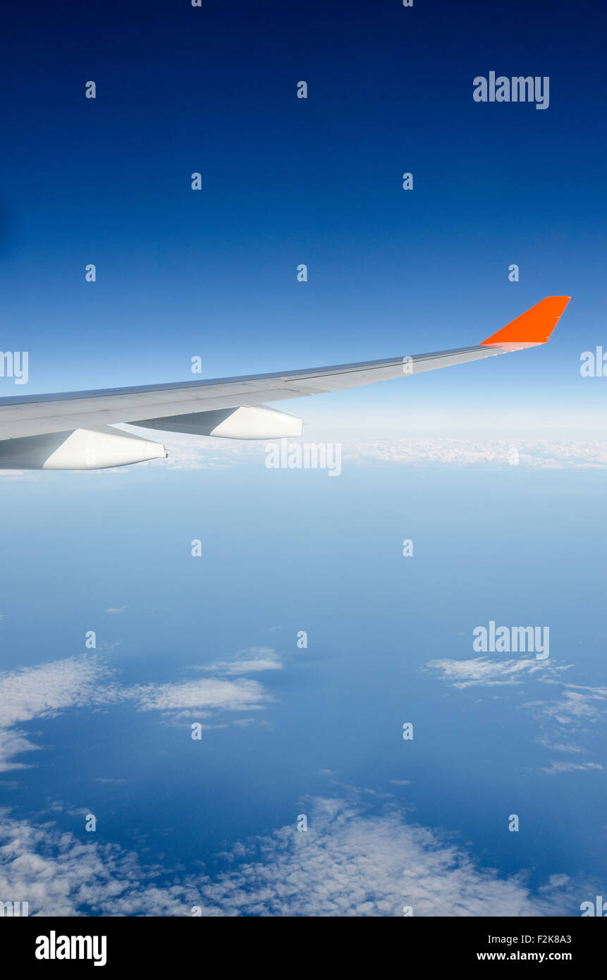 Plane wing, white clouds and blue sky Stock Photo - Alamy