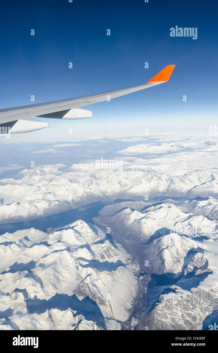 Plane wing, white clouds, blue sky and ground Stock Photo - Alamy