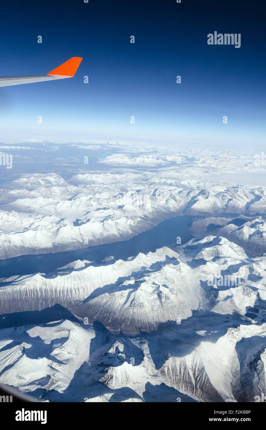 Plane wing, white clouds, blue sky and ground Stock Photo - Alamy