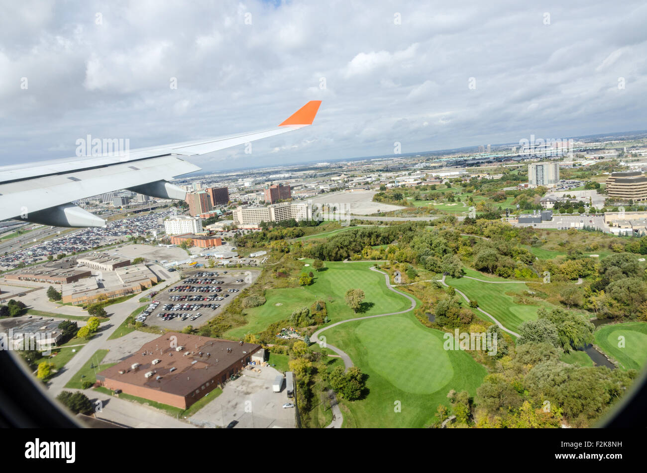 Plane wing, white clouds, blue sky and ground Stock Photo - Alamy